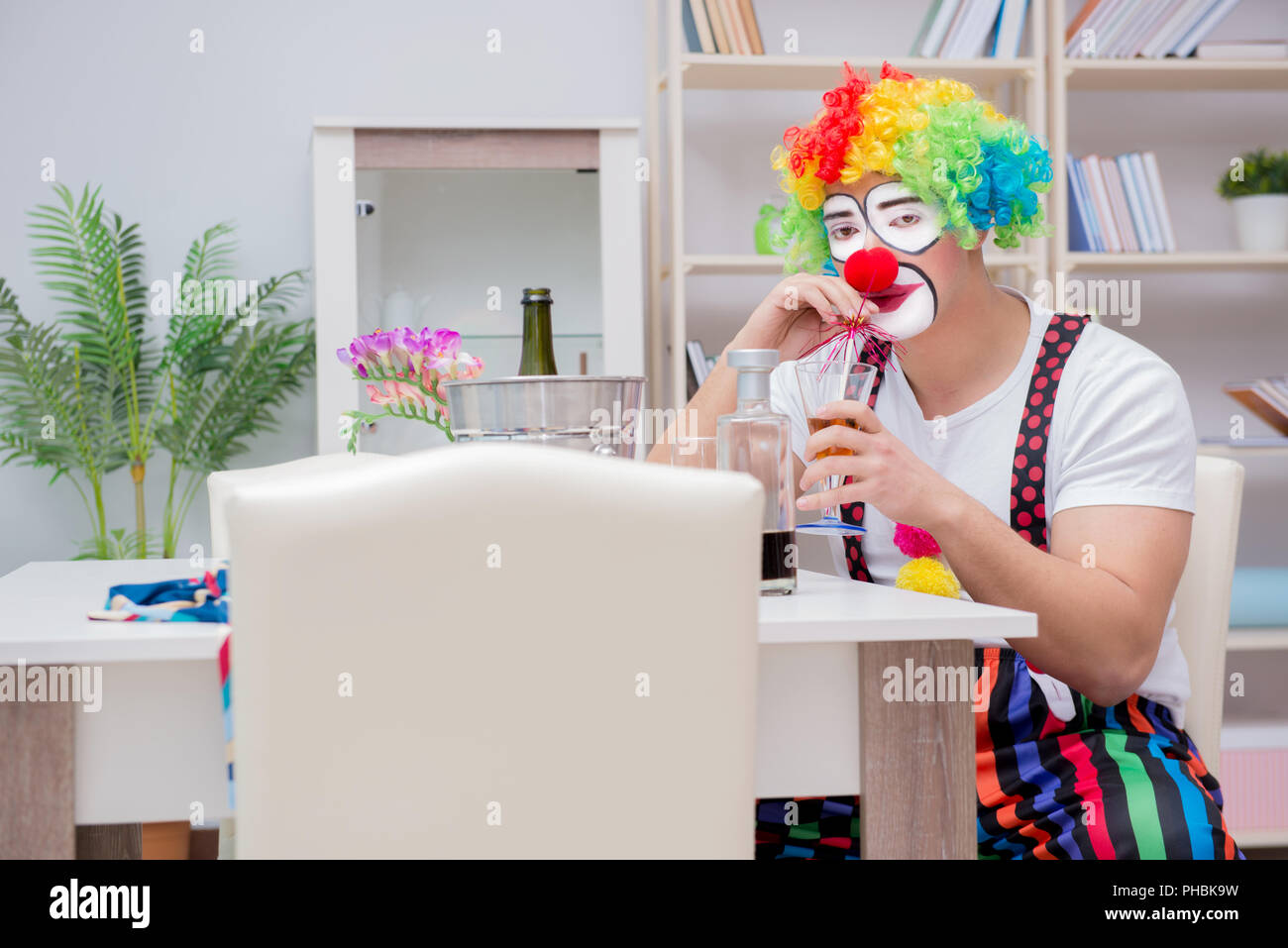 Drunk clown celebrating having a party at home Stock Photo - Alamy