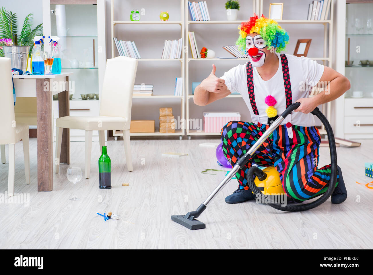 Funny clown doing cleaning at home Stock Photo - Alamy