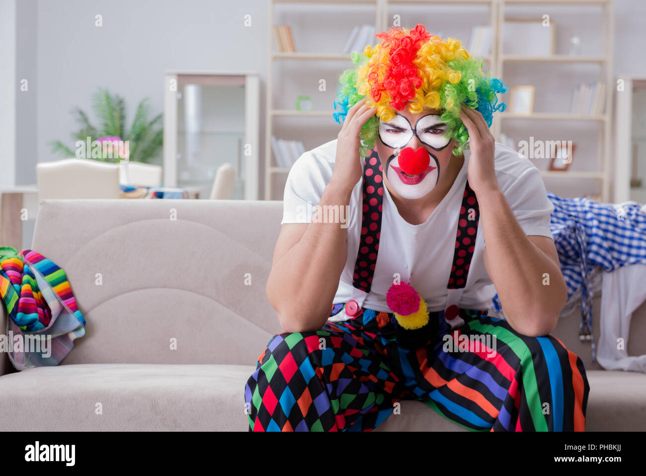 Drunk clown celebrating having a party at home Stock Photo - Alamy