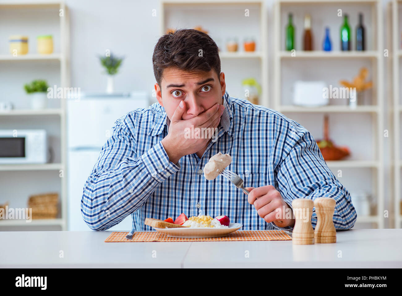 Man eating tasteless food at home for lunch Stock Photo - Alamy