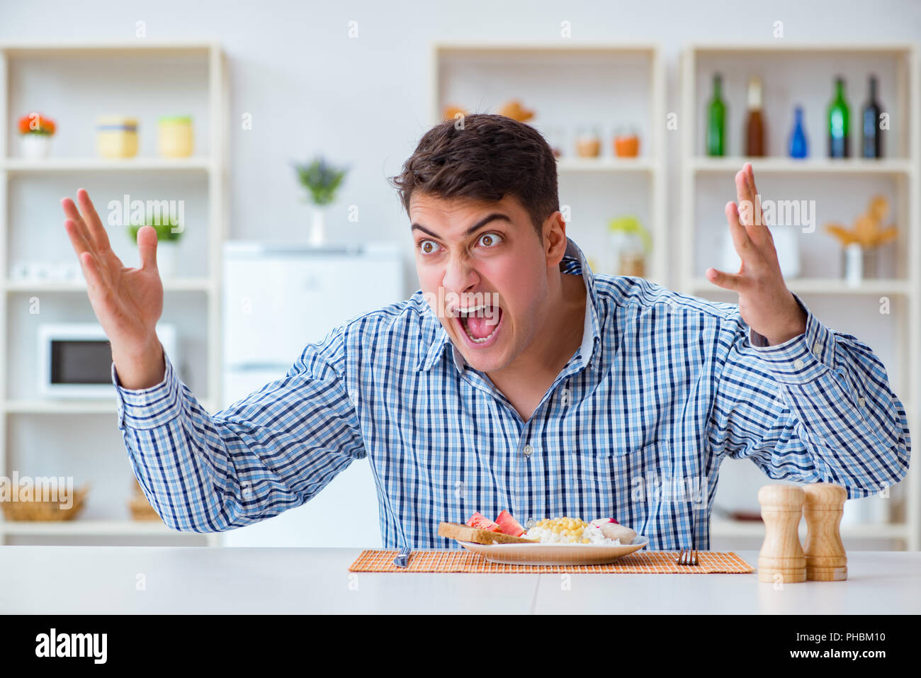 Young husband eating tasteless hi-res stock photography and images - Alamy