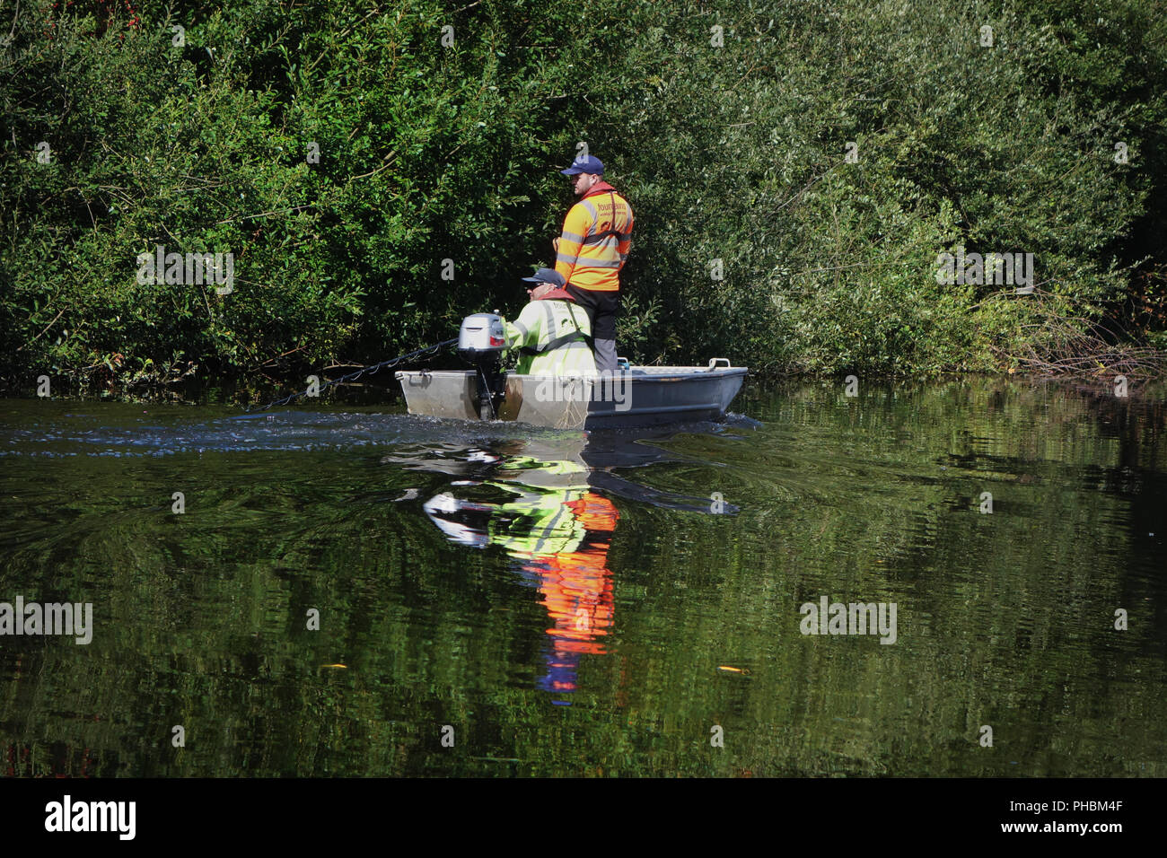 2 staff from The Canal and River Trust in the official boat spraying ...