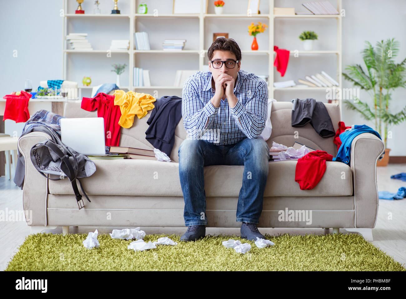 Young man working studying in messy room Stock Photo - Alamy