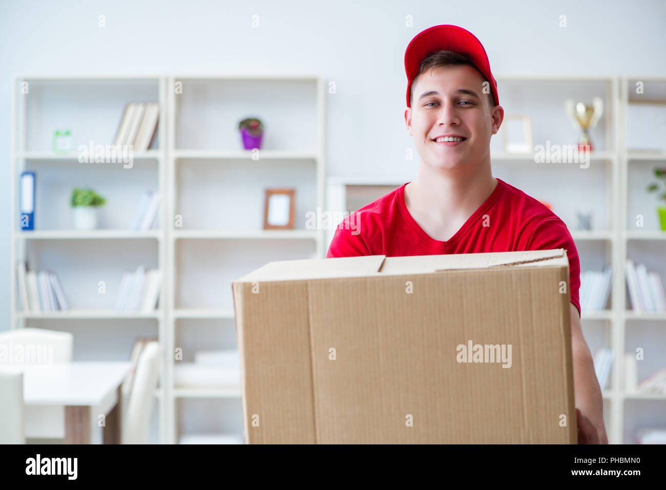Post man delivering a parcel package Stock Photo - Alamy