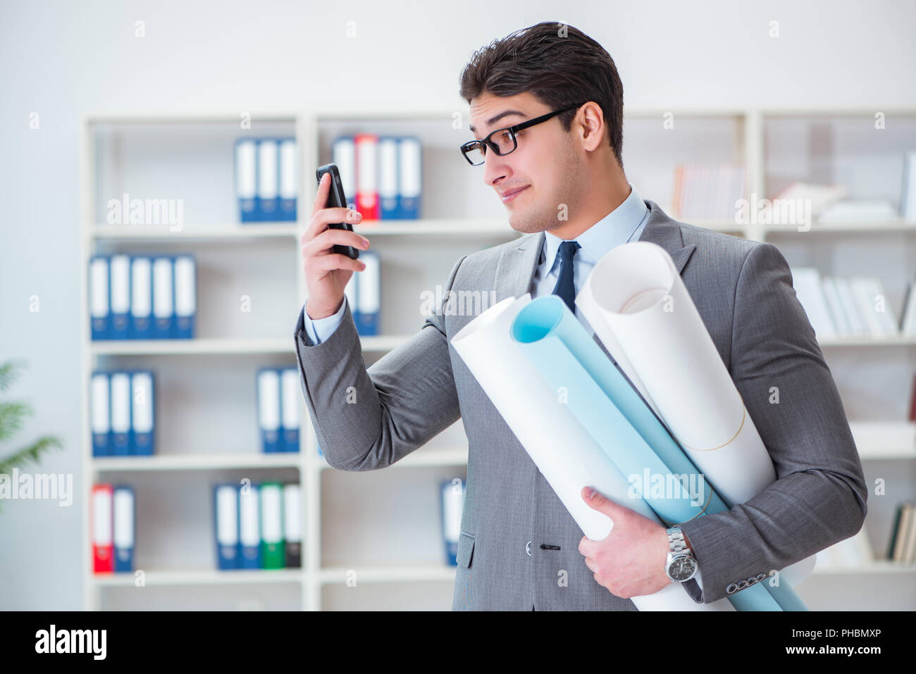 Businessman engineer draftsman with blueprints drawings Stock Photo - Alamy