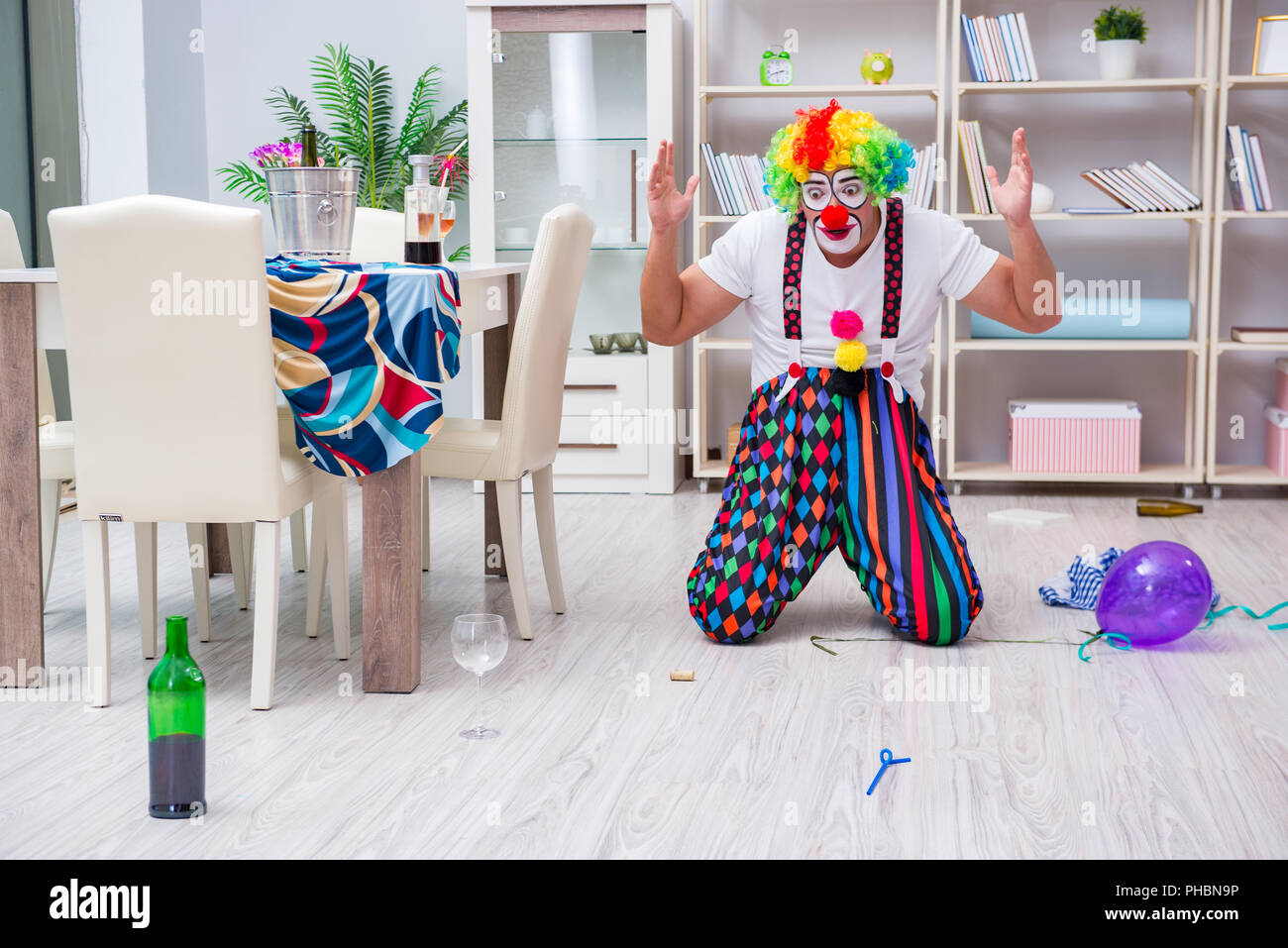 Drunk clown celebrating having a party at home Stock Photo - Alamy
