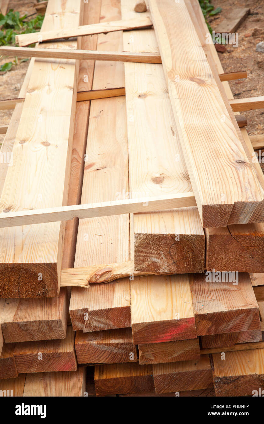 folded pine boards and beams for use in construction, closeup on the ...