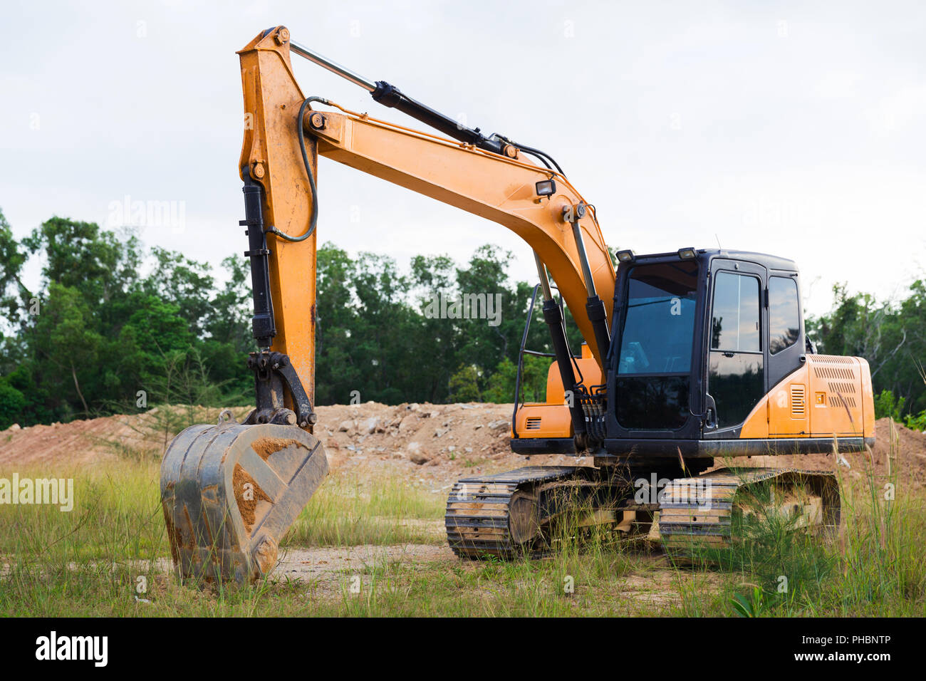 Yellow construction transport excavator digging earth outdoors concept ...