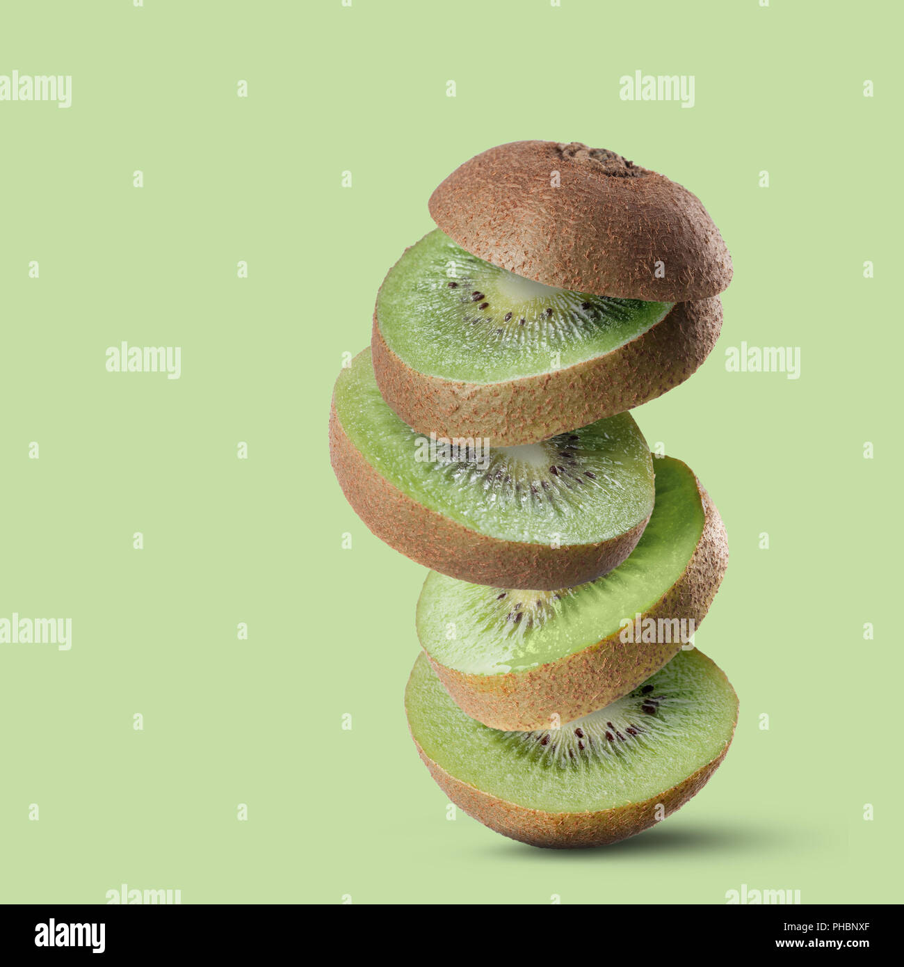 Falling slices of kiwi fruit isolated Stock Photo - Alamy