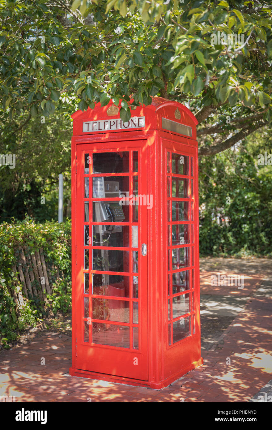 Classical red telephone booth in English trees, United Kingdom Stock ...