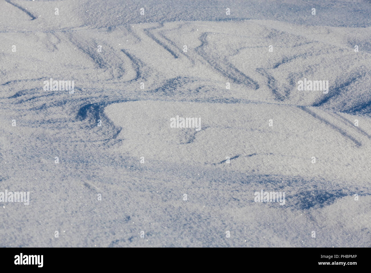illuminated surface of snow, part of the surface is in shadow ...