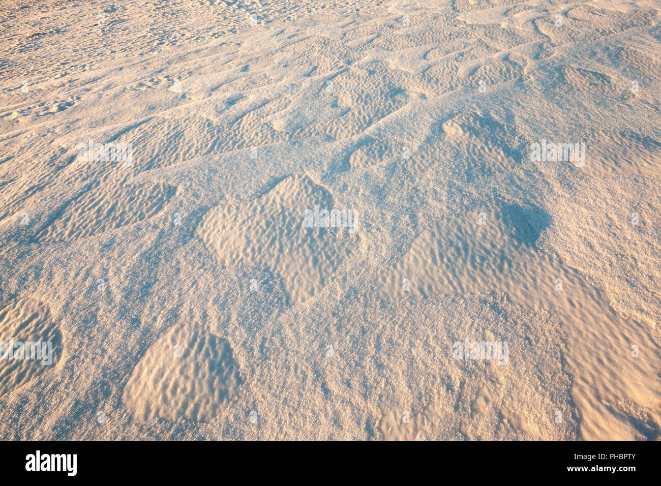 beautiful pattern of wavy uneven snow in the winter season, close-up of ...