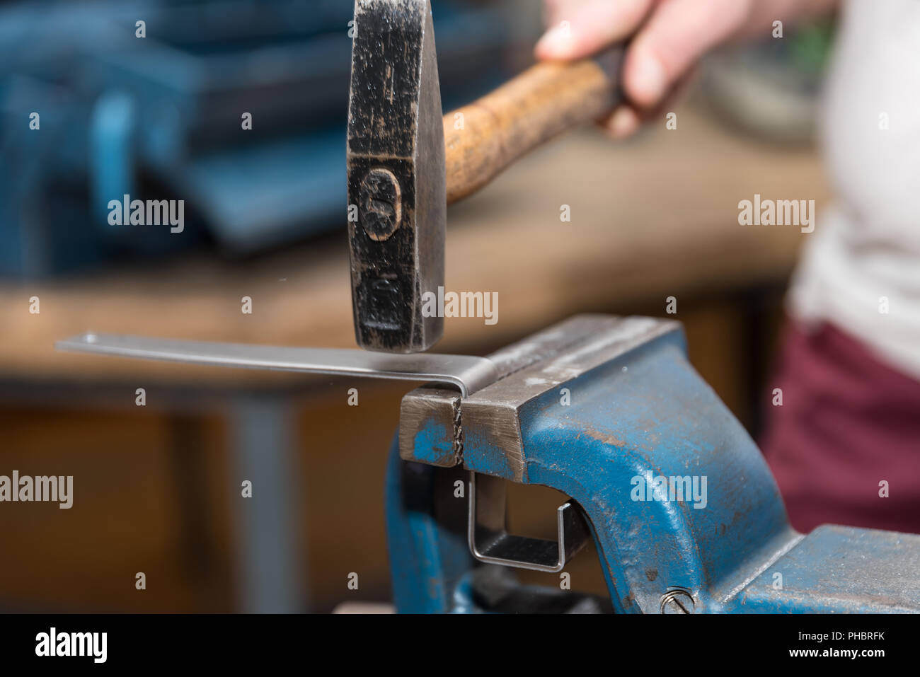 Metal piece is worked with a hammer - close-up Stock Photo - Alamy