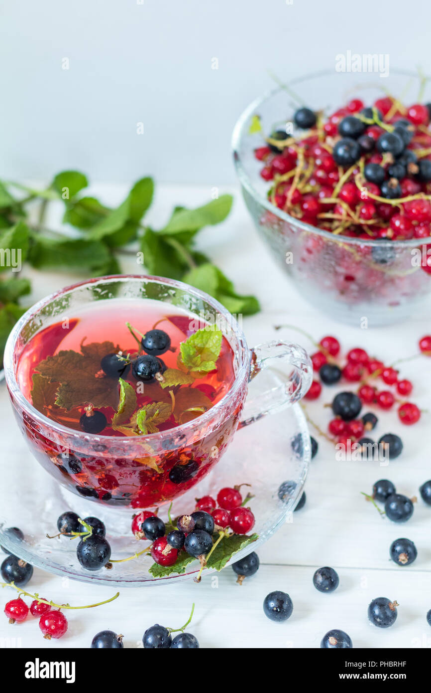 Fruit drink in transparent glass carafe and cup Stock Photo - Alamy