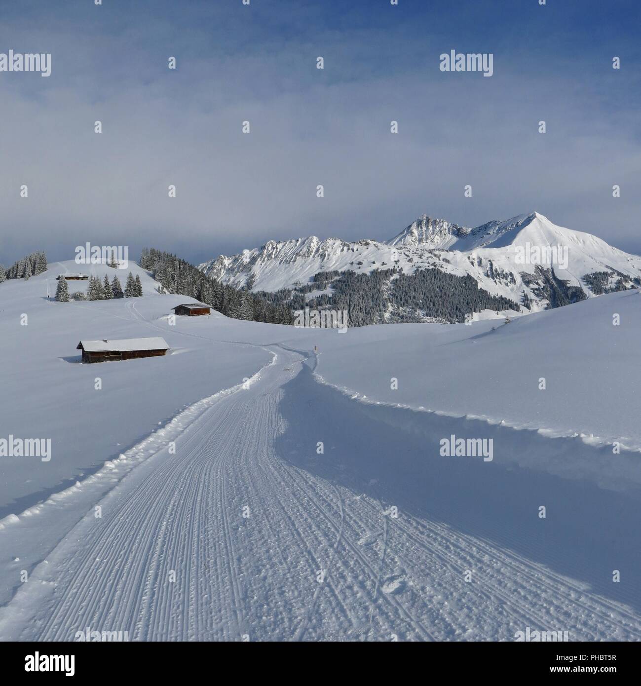 Winter scene in Gstaad, Switzerland. Snow covered mount Lauenenhorn ...