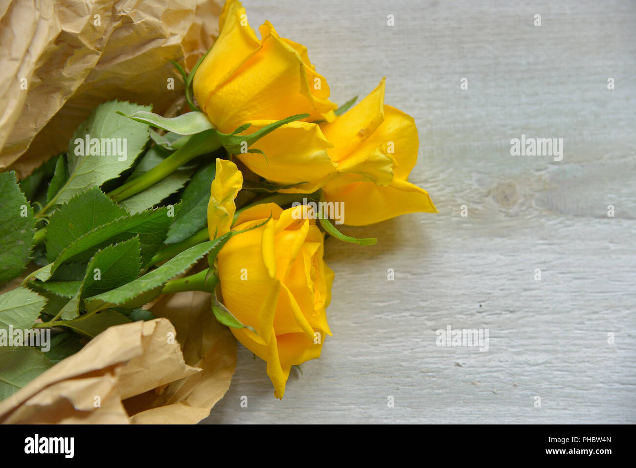Yellow roses brown paper bag Stock Photo - Alamy