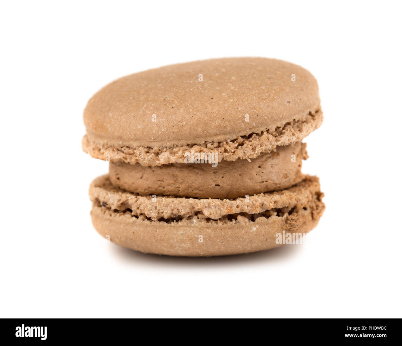 Single brown french macaroon cookie Stock Photo - Alamy