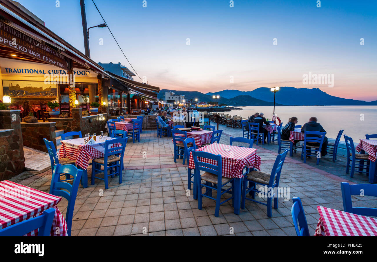 Traditional Cretan Food Restaurant at Paraliaki promenade at sunset in ...