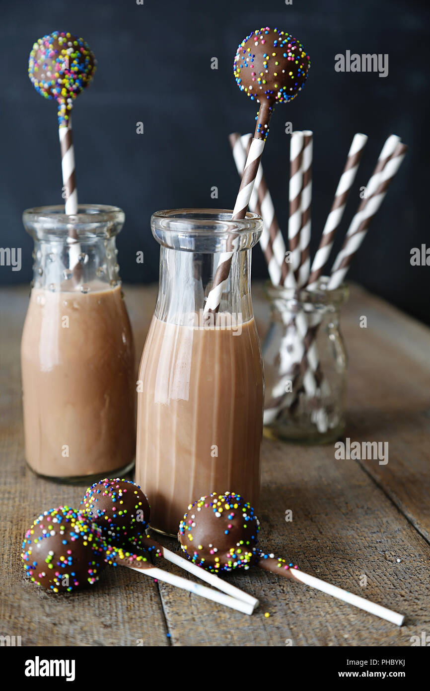 Bottles of chocolate milk with straws and cake pops Stock Photo - Alamy