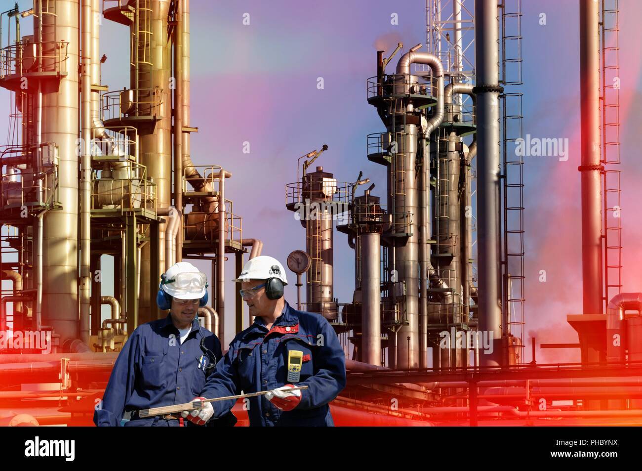 Two oil and gas engineers in front of a oil and fuel refinery Stock ...