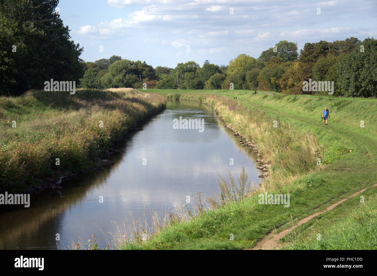 People enjoy the last of the Summer's sunshine beside the river Mersey ...