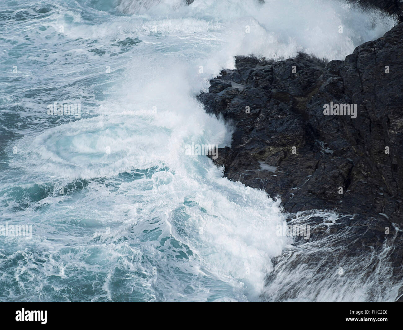 Water crashing against rocks on the Cornish Coast Stock Photo - Alamy