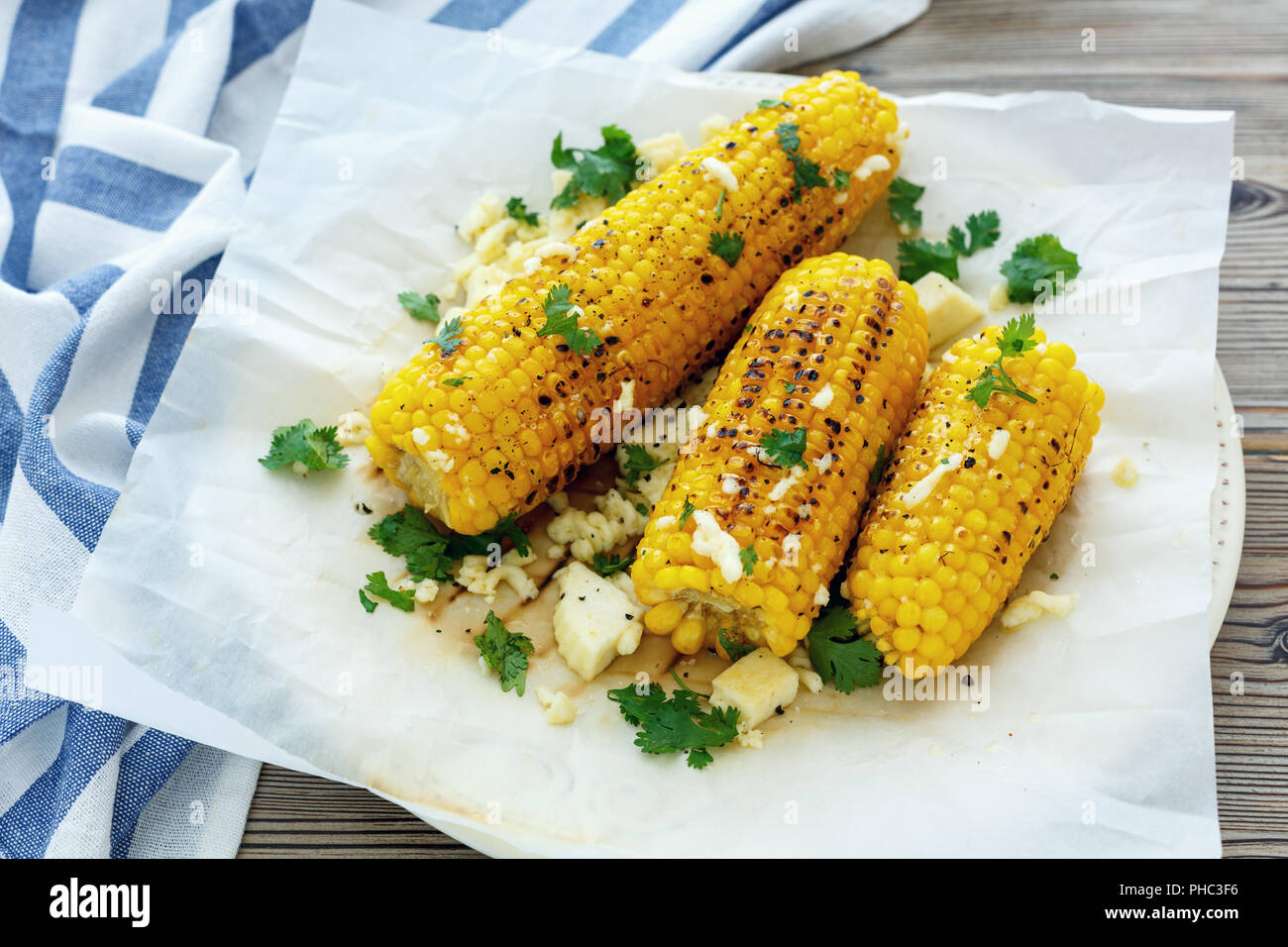 Sweet corn grilled with cheese and cilantro Stock Photo - Alamy