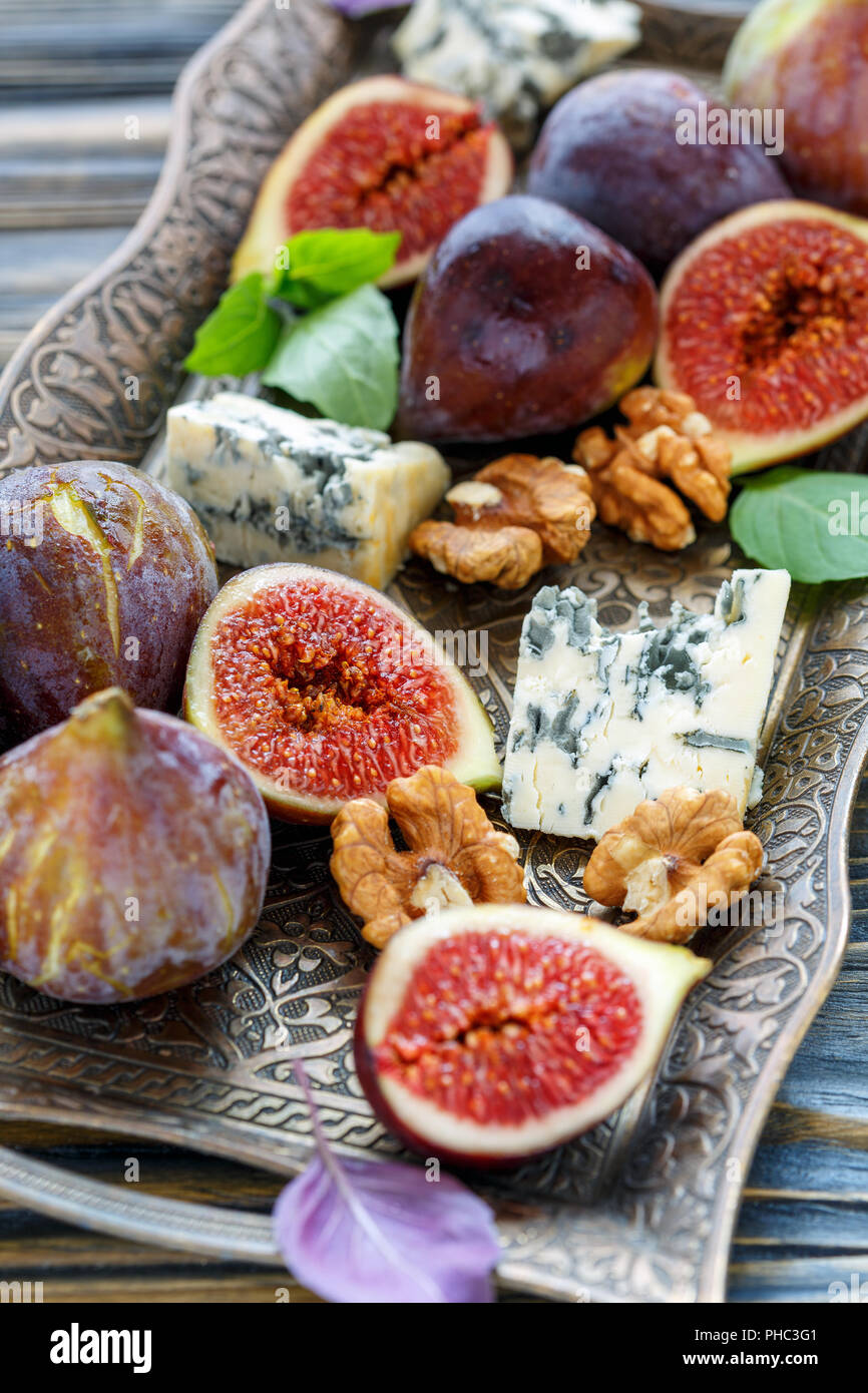Fresh figs with blue cheese on a bronze tray Stock Photo - Alamy
