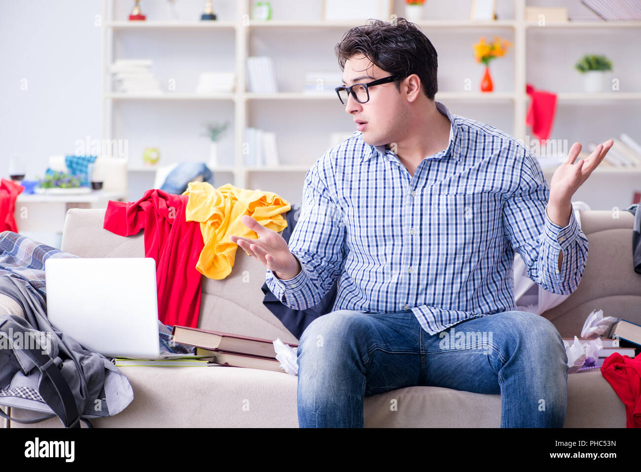 Young man working studying in messy room Stock Photo - Alamy