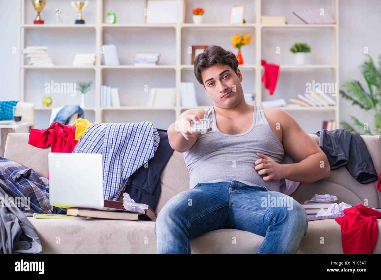 Young man working studying in messy room Stock Photo - Alamy
