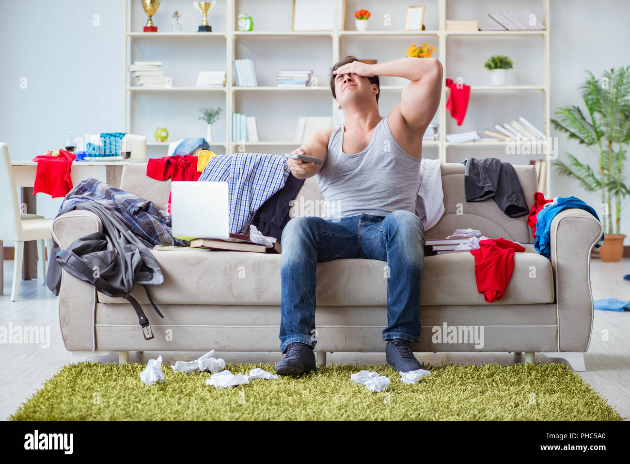 Young man working studying in messy room Stock Photo - Alamy