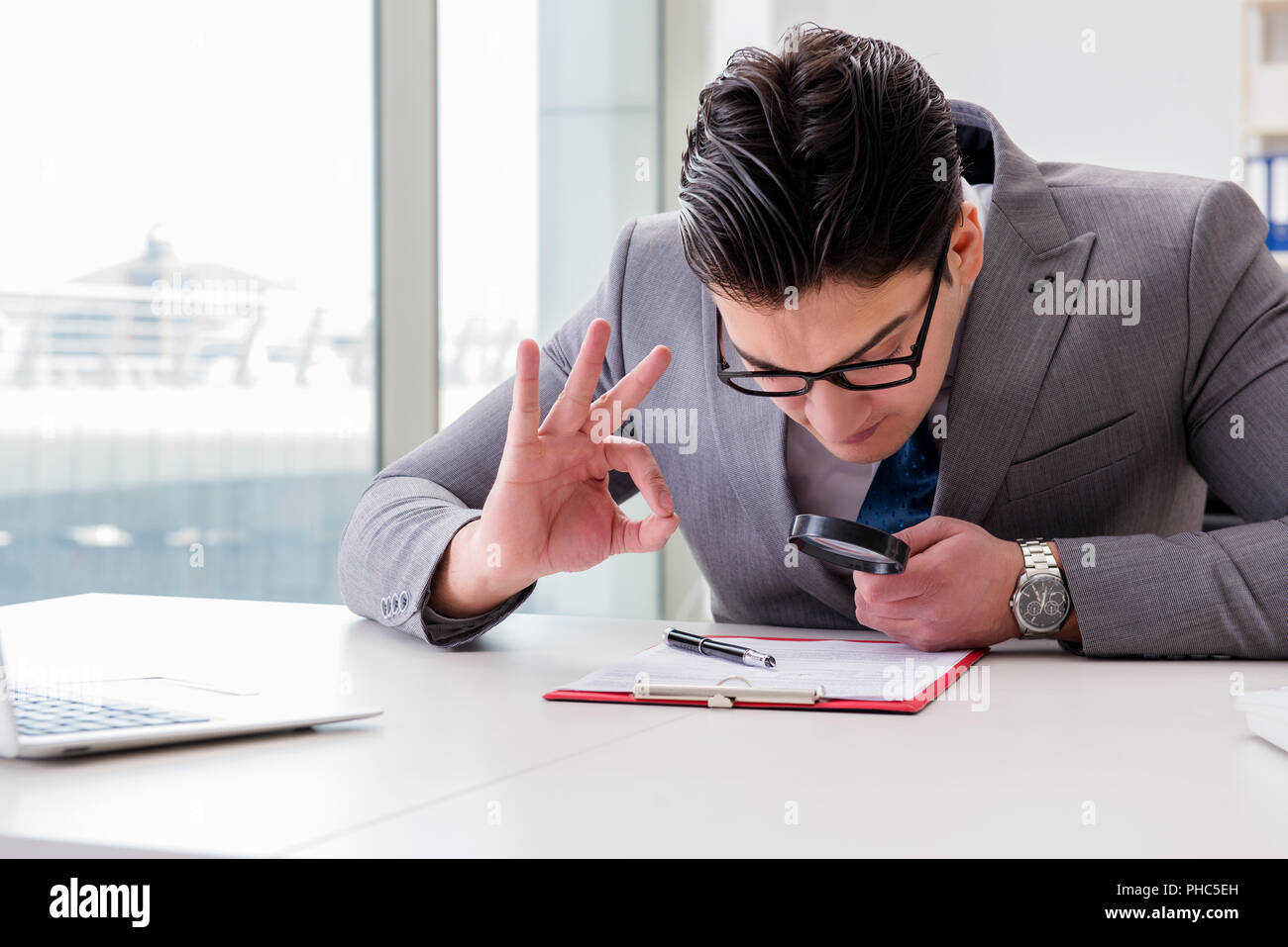 Man looking for errors and mistakes in report Stock Photo - Alamy
