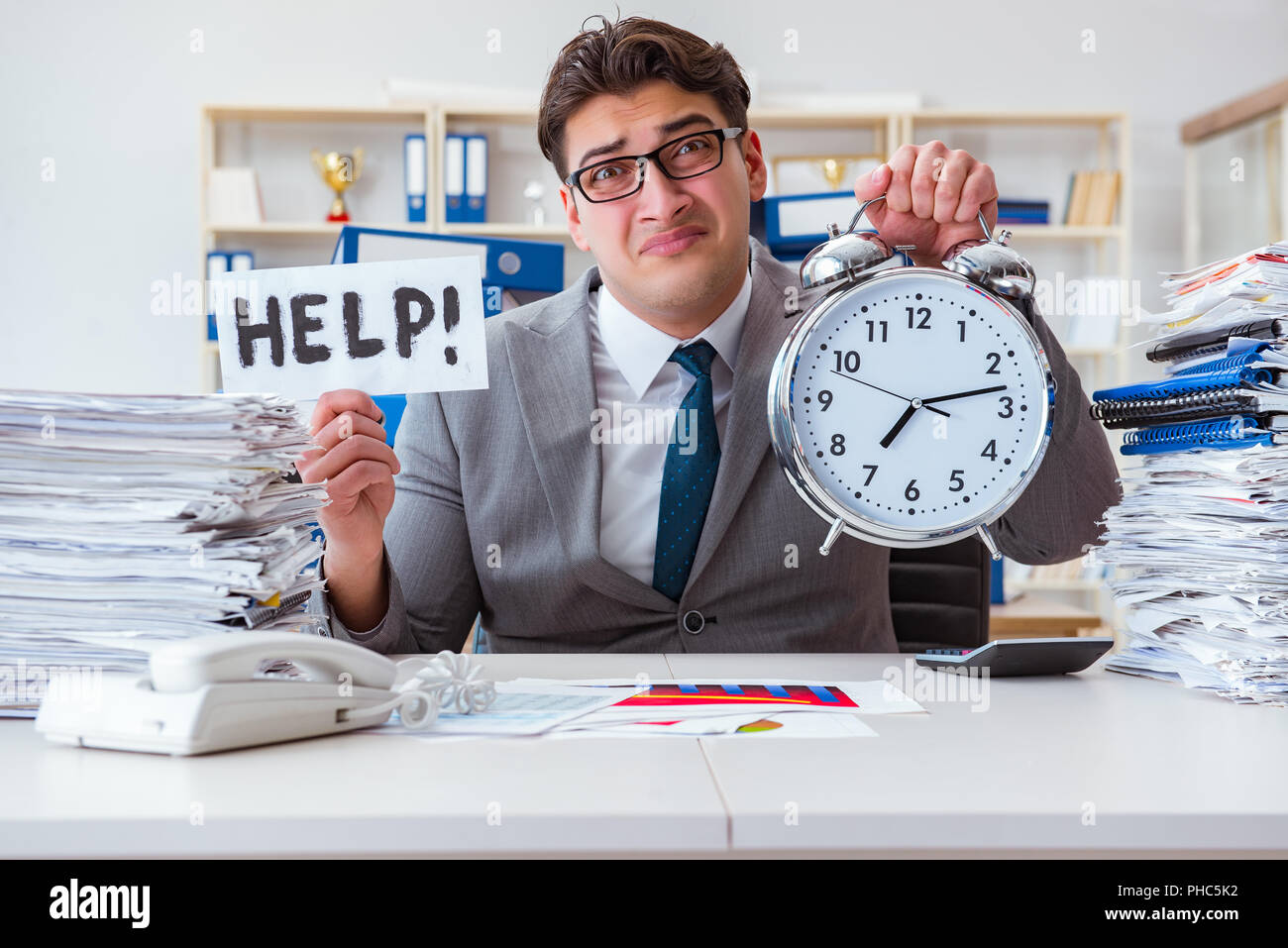 Businessman missing deadlines due to excessive work Stock Photo - Alamy