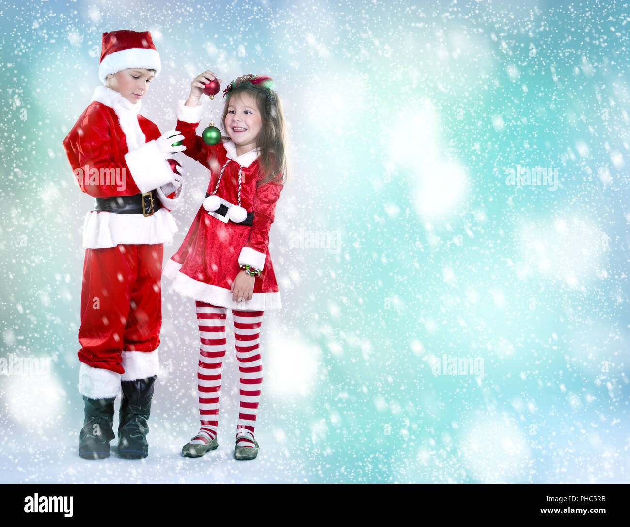 boy and girl as santa and elf Stock Photo - Alamy