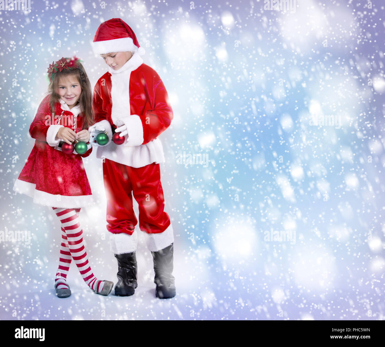 boy and girl as santa and elf Stock Photo - Alamy
