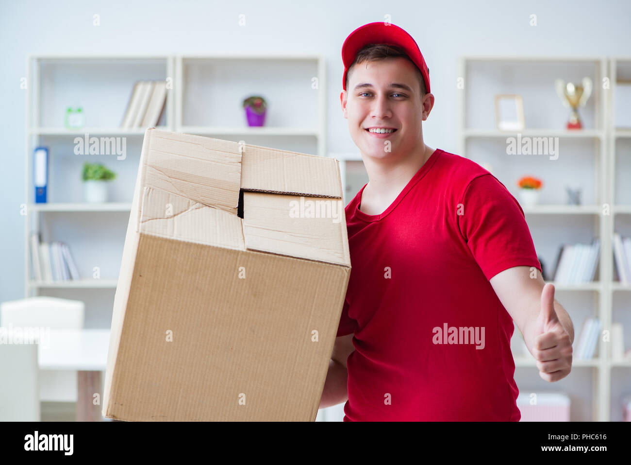 Post man delivering a parcel package Stock Photo - Alamy
