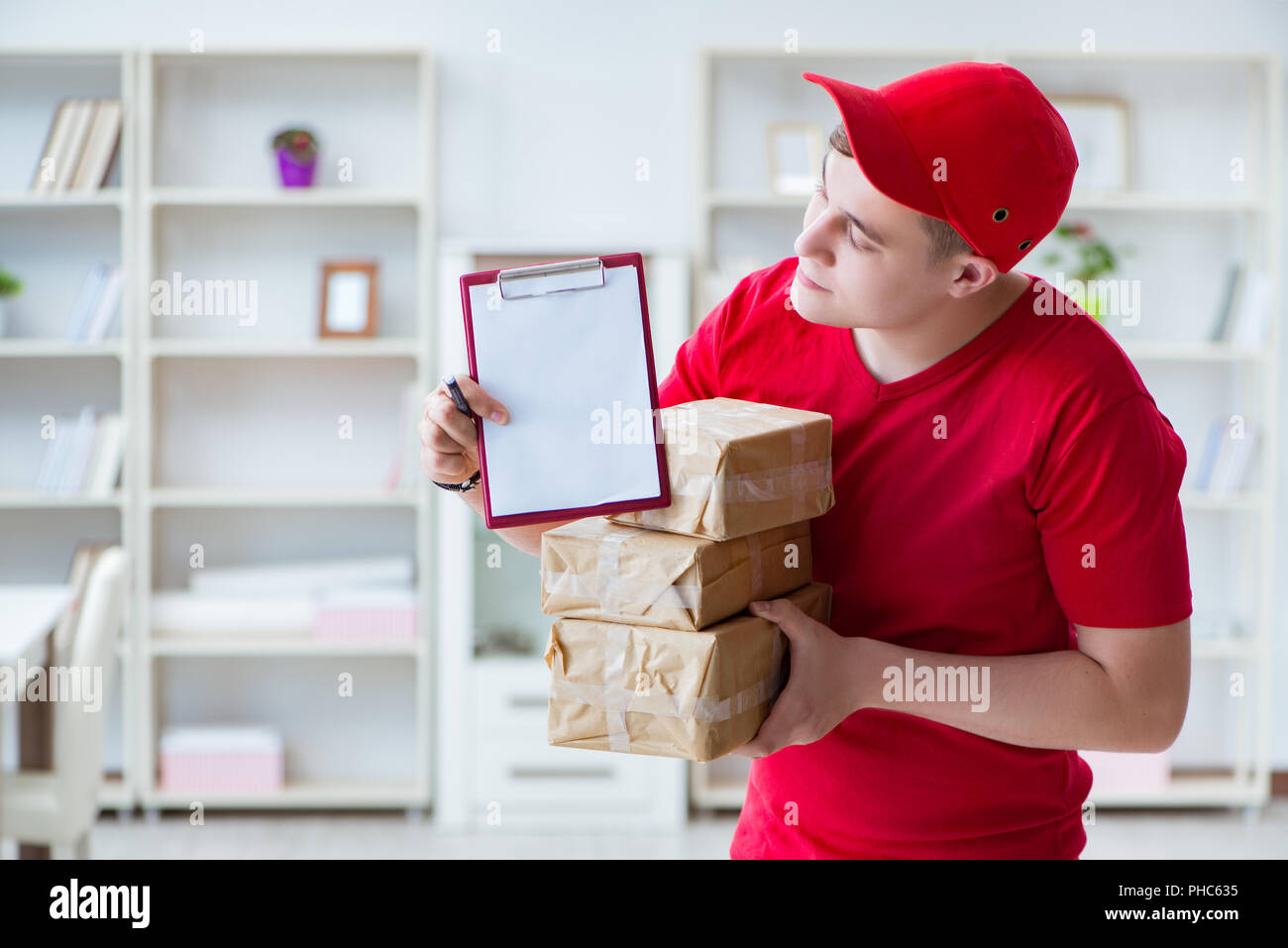 Post man delivering a parcel package Stock Photo - Alamy