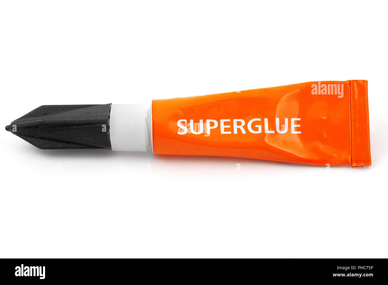 orange plastic tube labeled superglue Stock Photo - Alamy