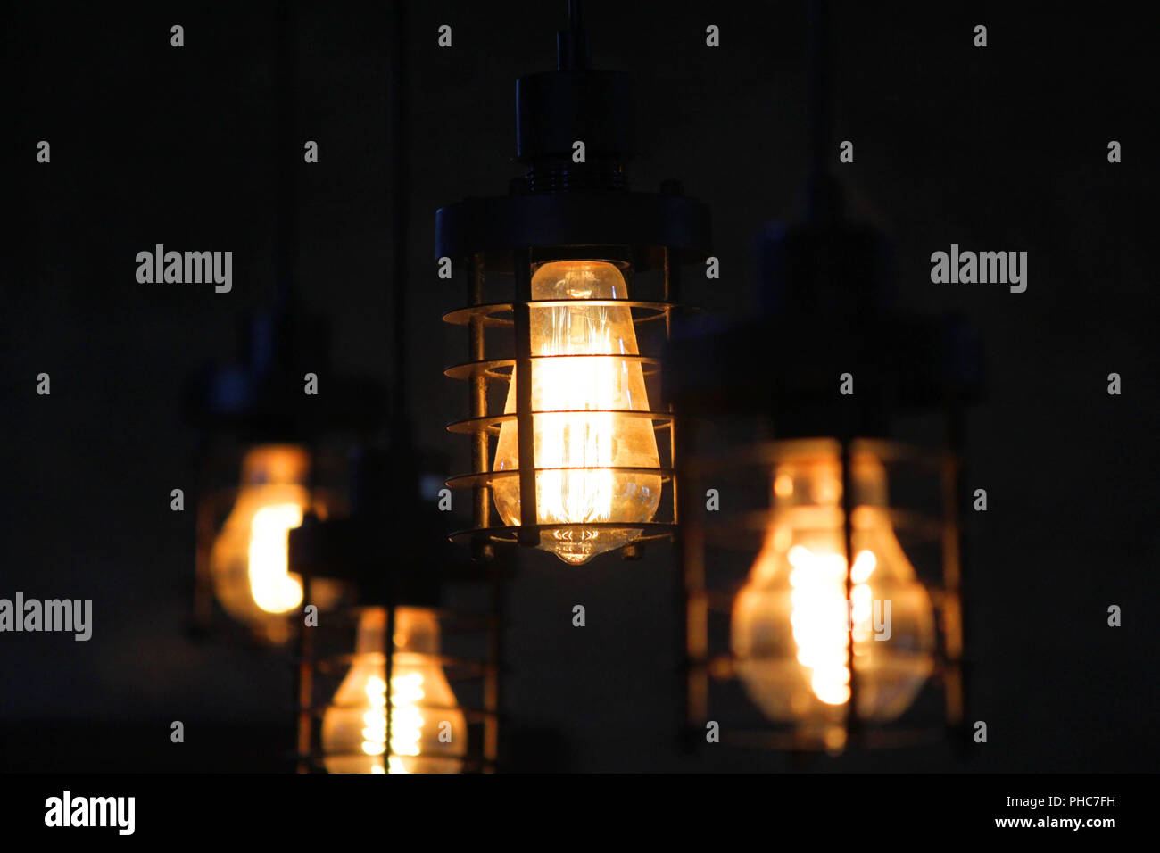 decorative lamp with turn on light bulb hanging on ceiling Stock Photo ...