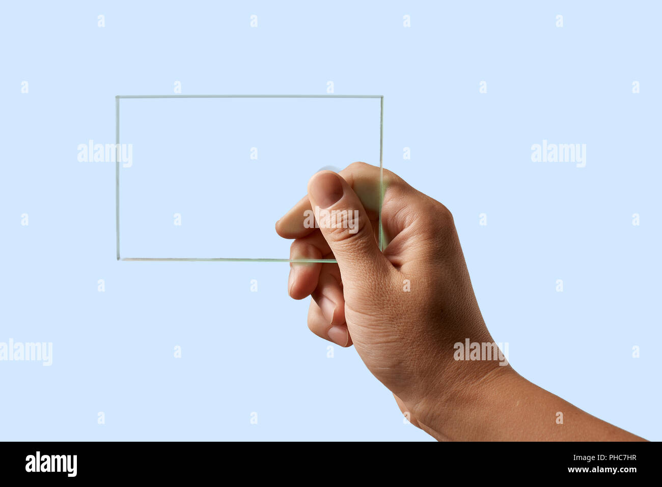 man's hand holds a transparent glass Stock Photo - Alamy