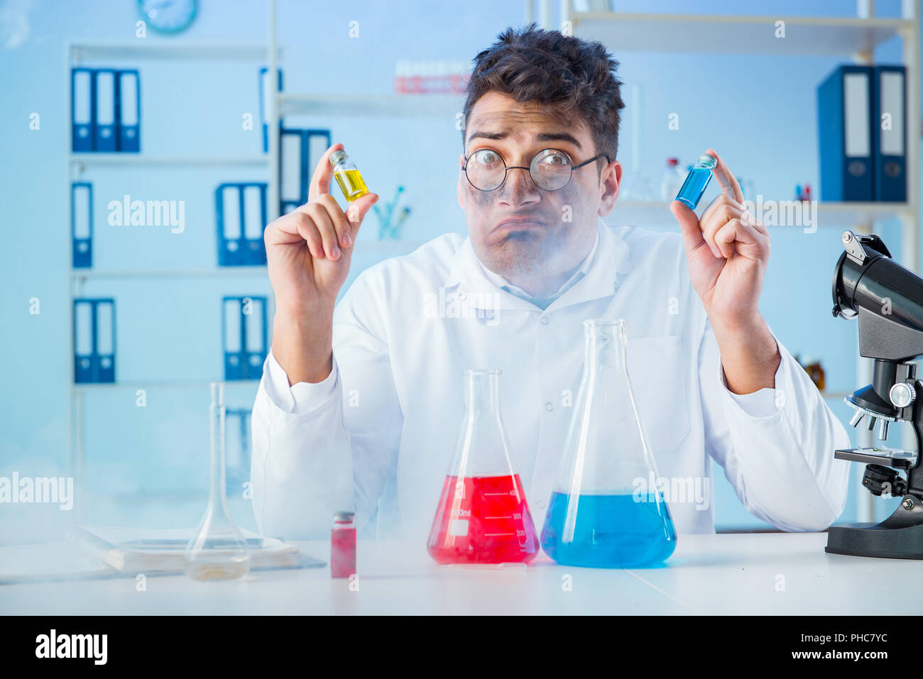 The funny mad chemist working in a laboratory Stock Photo - Alamy