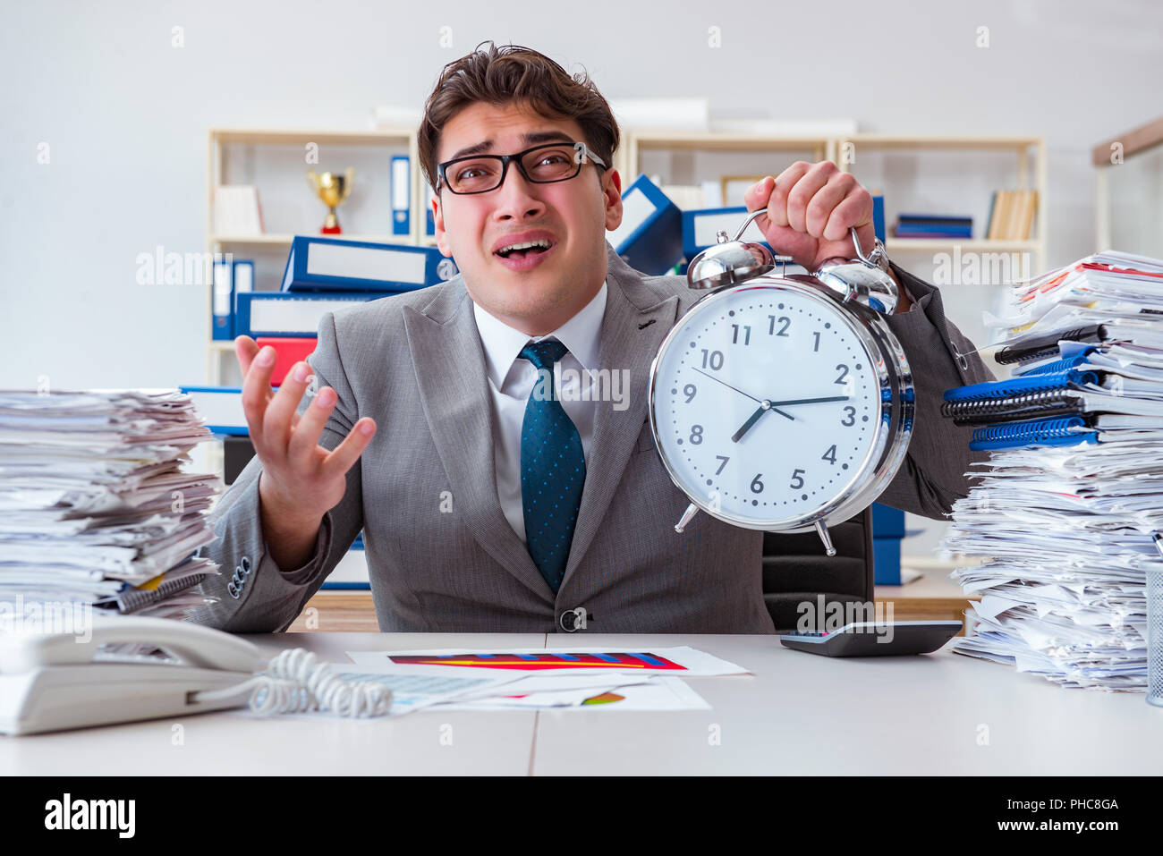 The businessman missing deadlines due to excessive work Stock Photo - Alamy
