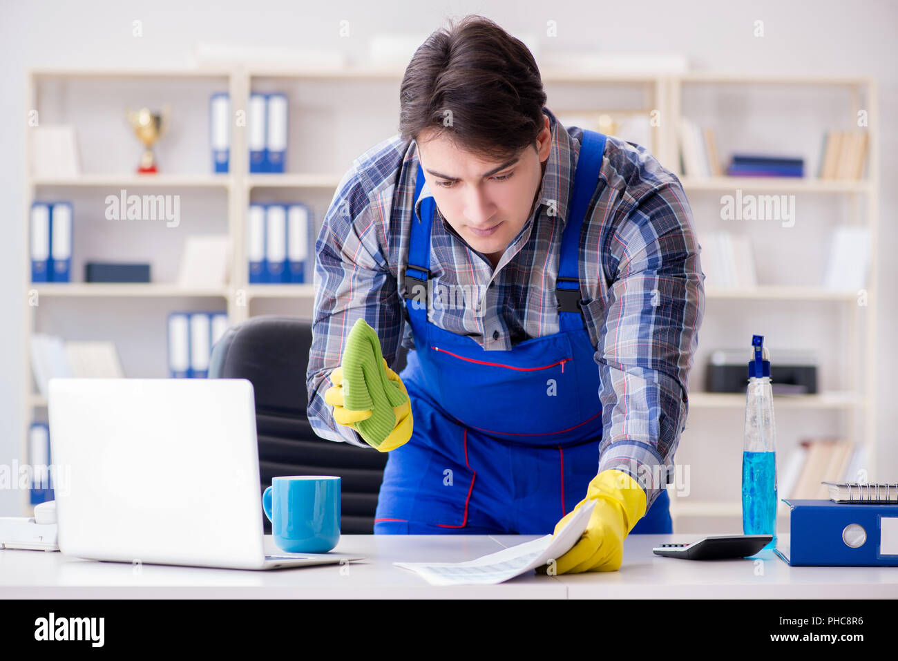 The male cleaner working in the office Stock Photo - Alamy