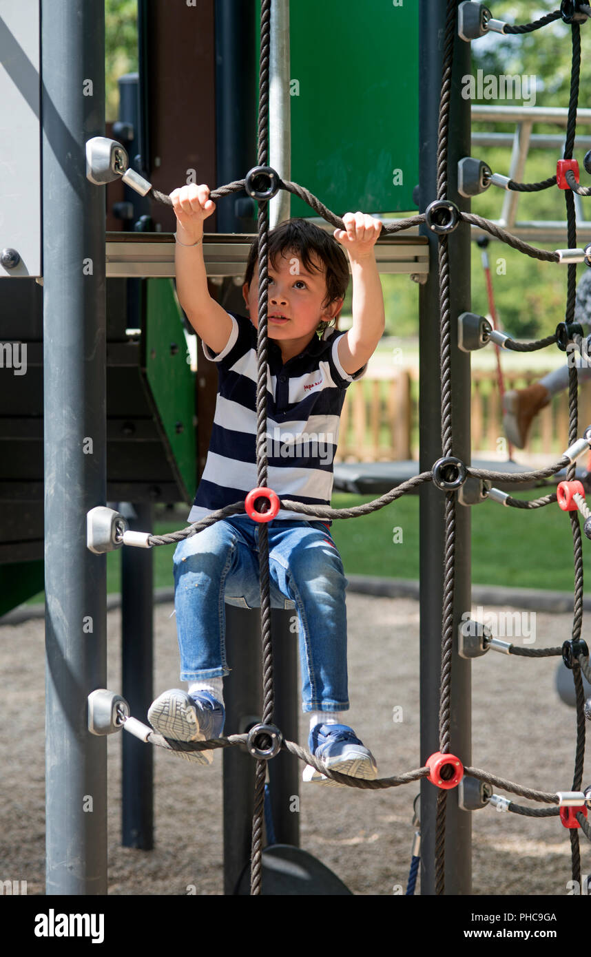Child climbing on a rope ladder Stock Photo - Alamy