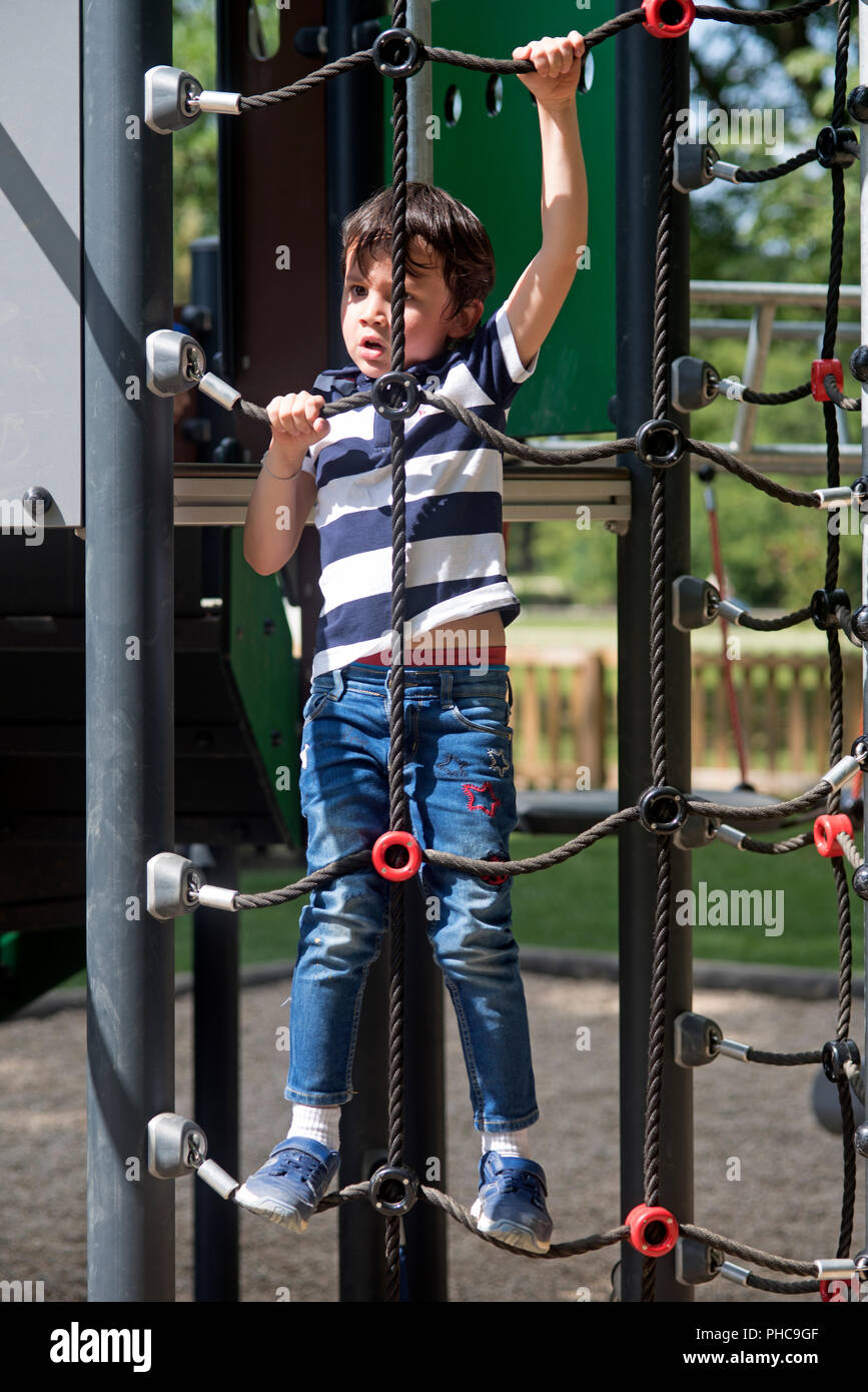 Child climbing on a rope ladder Stock Photo - Alamy
