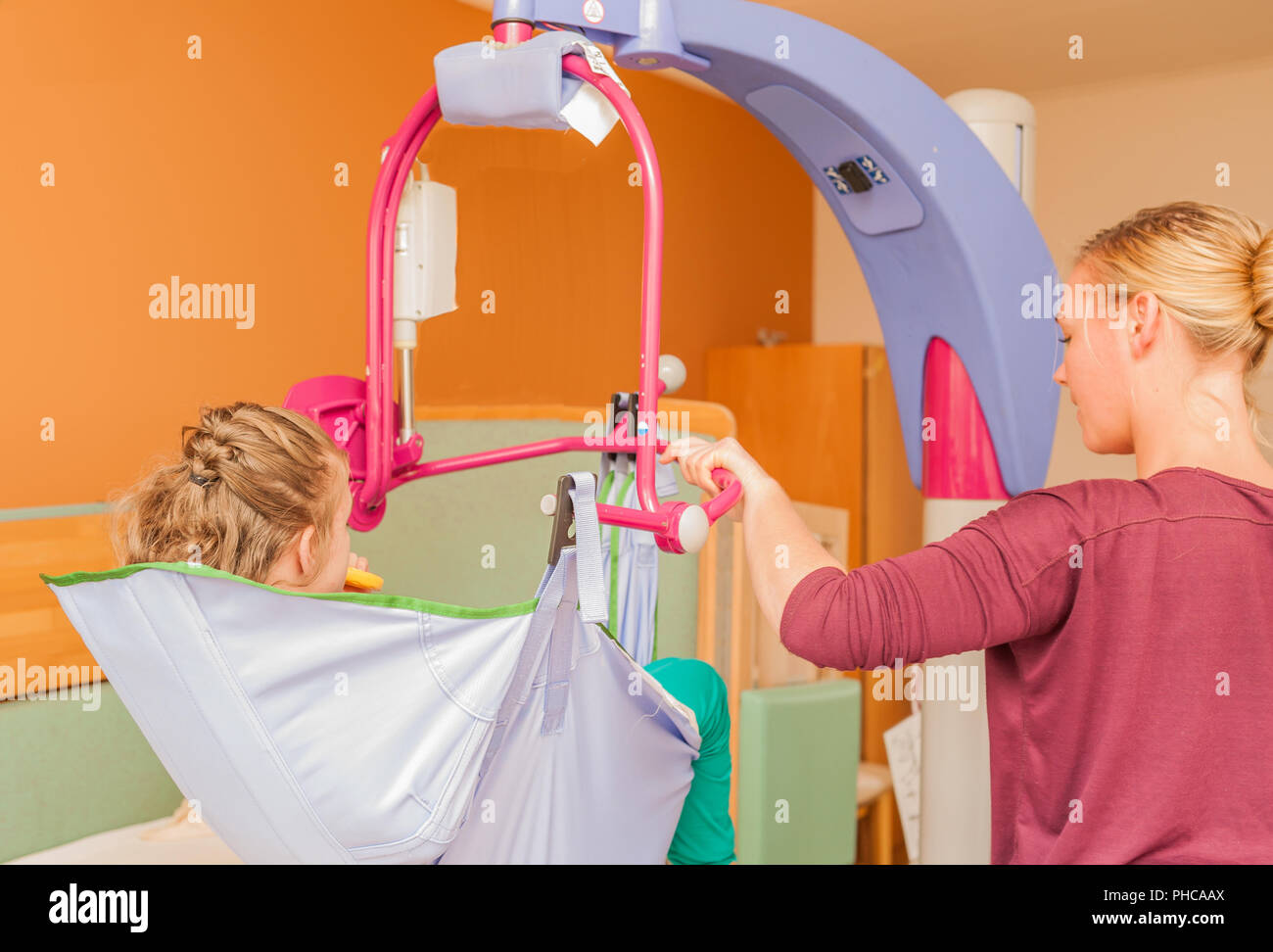 A disabled child being cared for by a special needs carer Stock Photo ...
