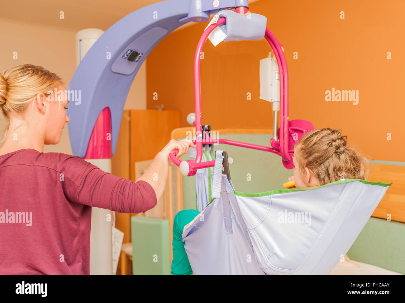 A disabled child being cared for by a special needs carer Stock Photo ...