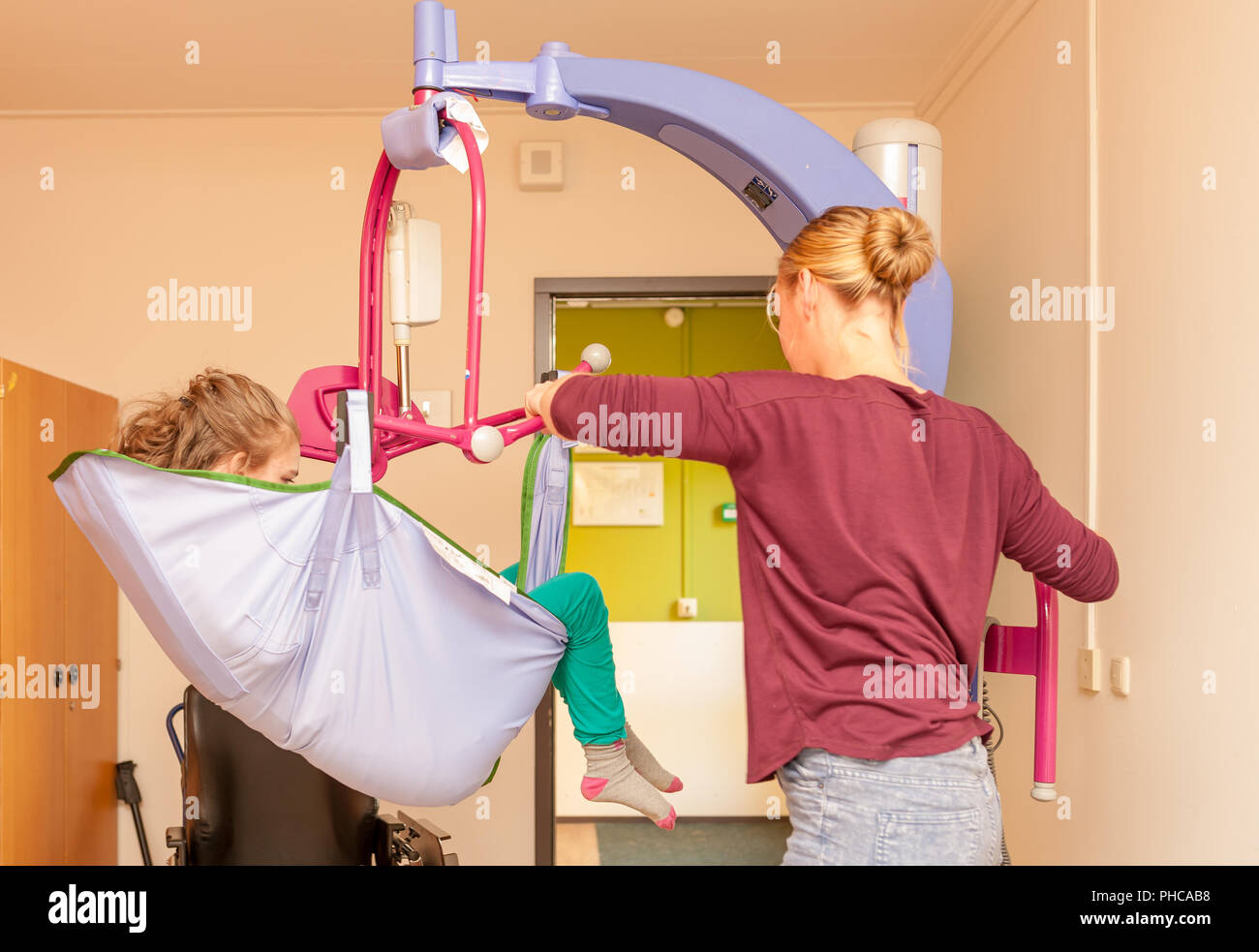 A disabled child being cared for by a special needs carer Stock Photo ...