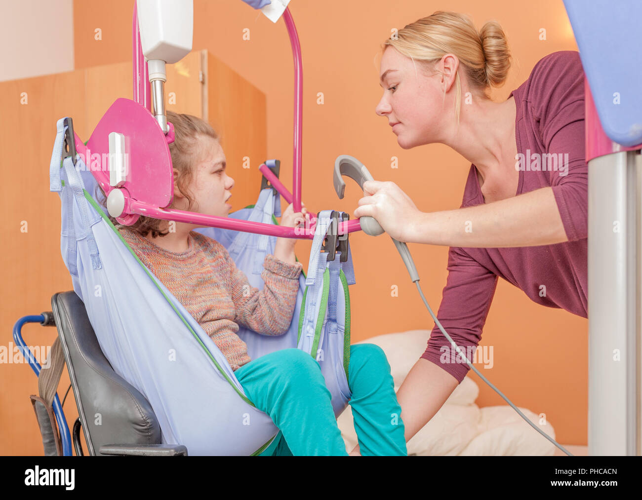A disabled child being cared for by a special needs carer Stock Photo ...