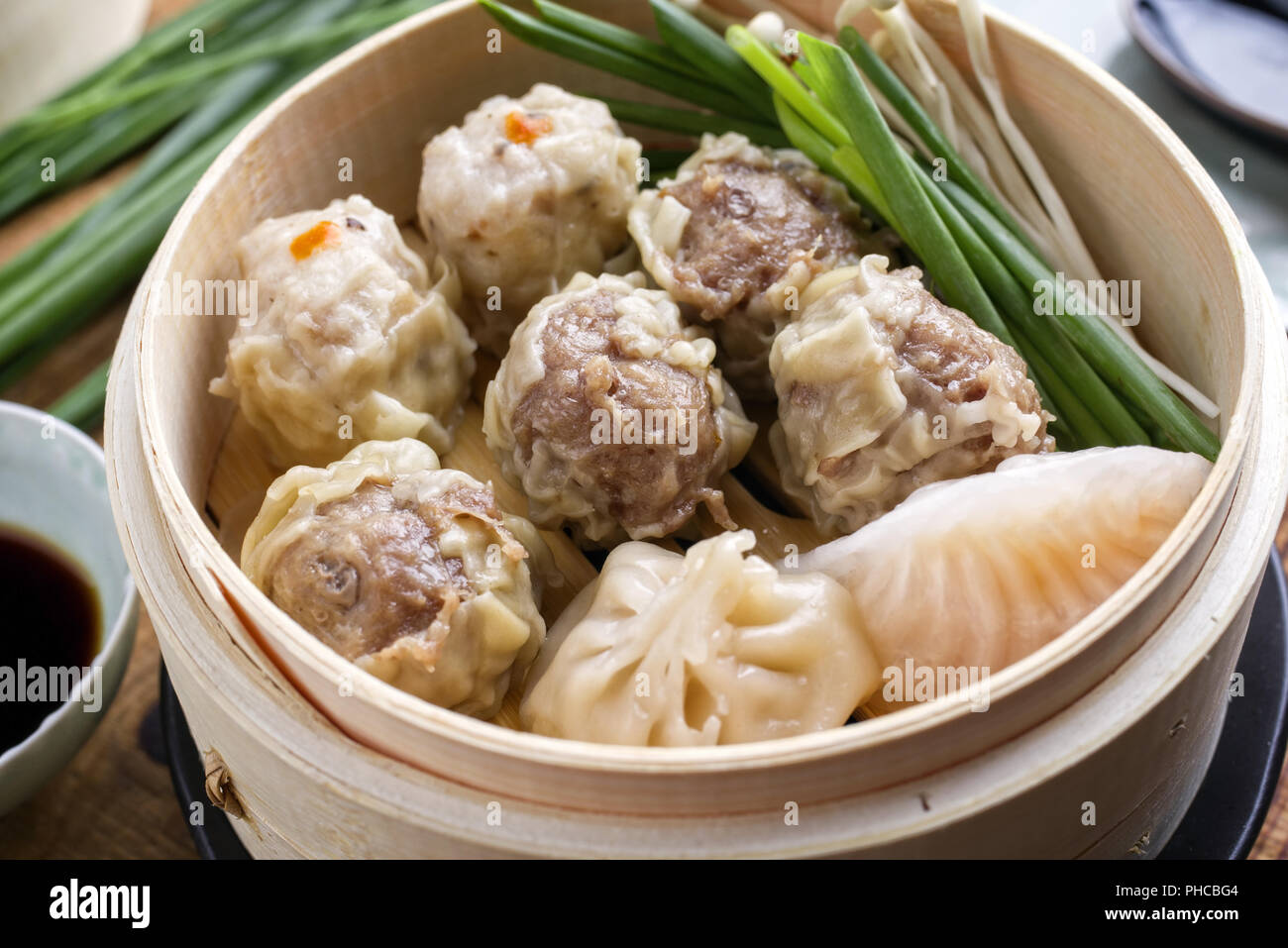 Traditional Chinese Dim Sum as close-up on Bamboo Steamer Stock Photo ...